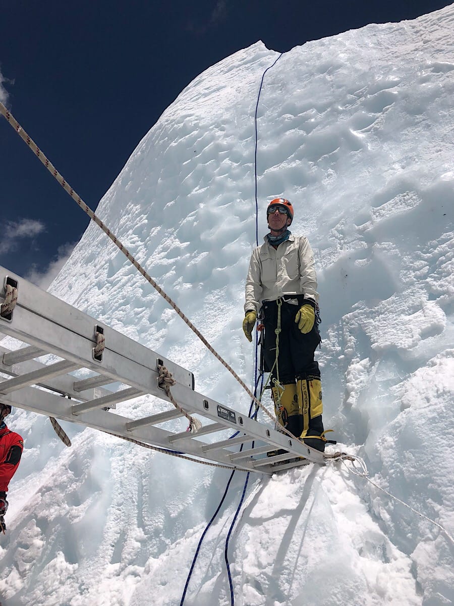 Rob standing at the ladder crossing. Courtesy of Adventure Consultants ...